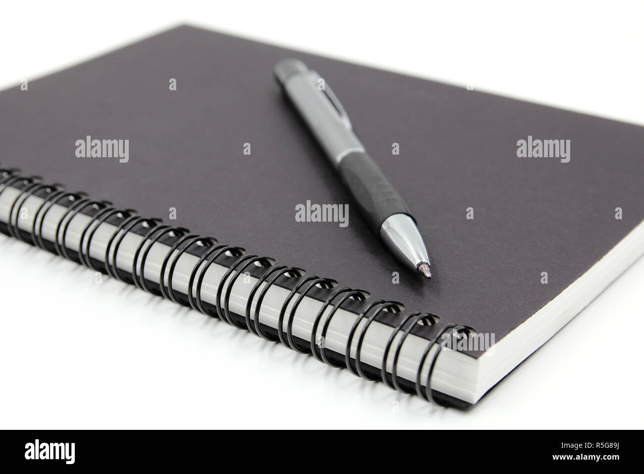 Notebook and pen isolated on white background Stock Photo - Alamy