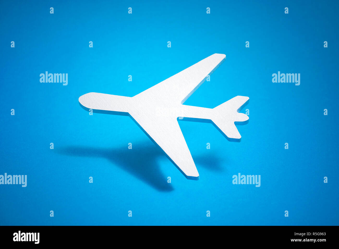 Airplane shape over blue background Stock Photo - Alamy