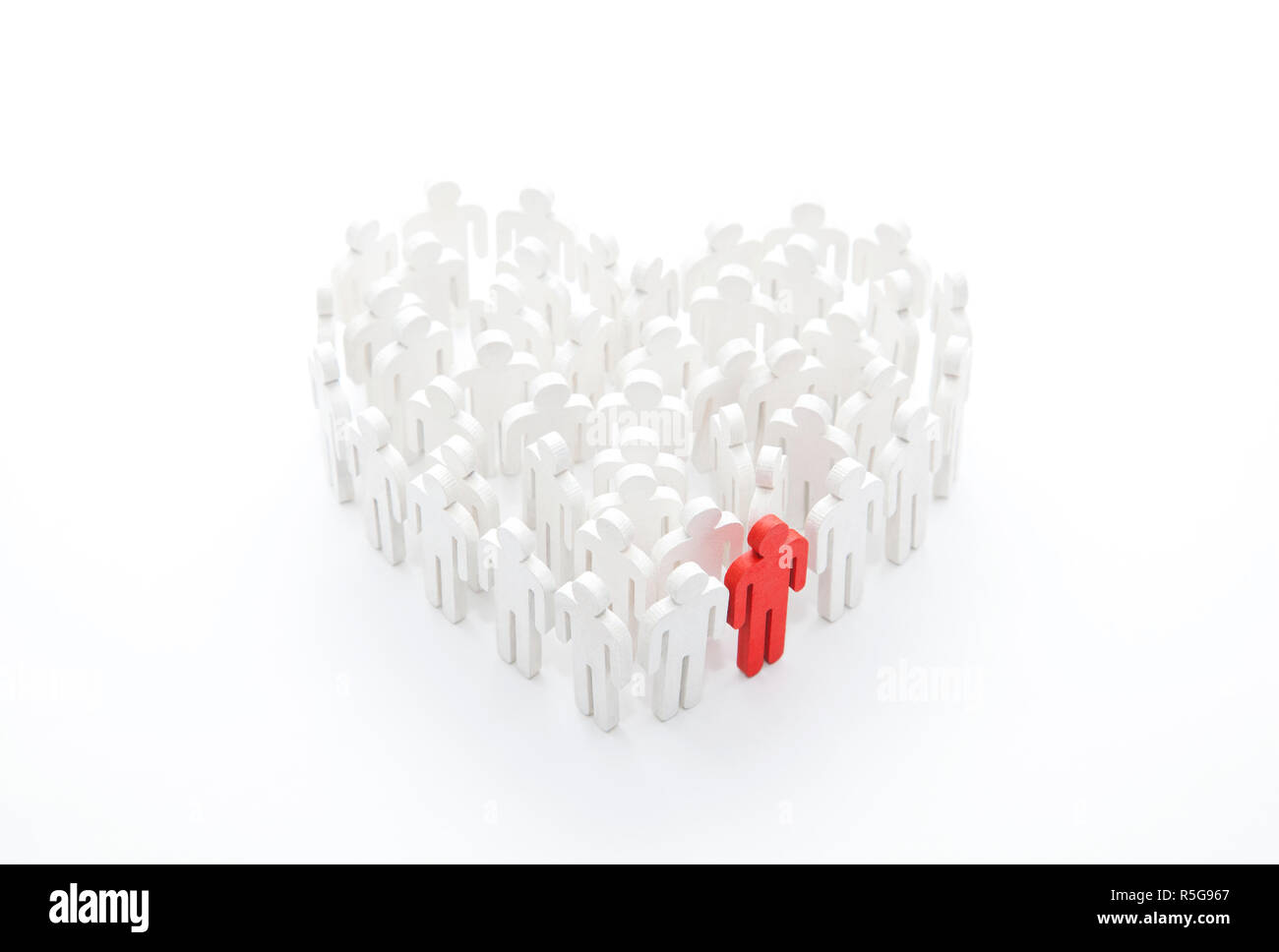 Group of people in the shape of a heart with one red person Stock Photo ...