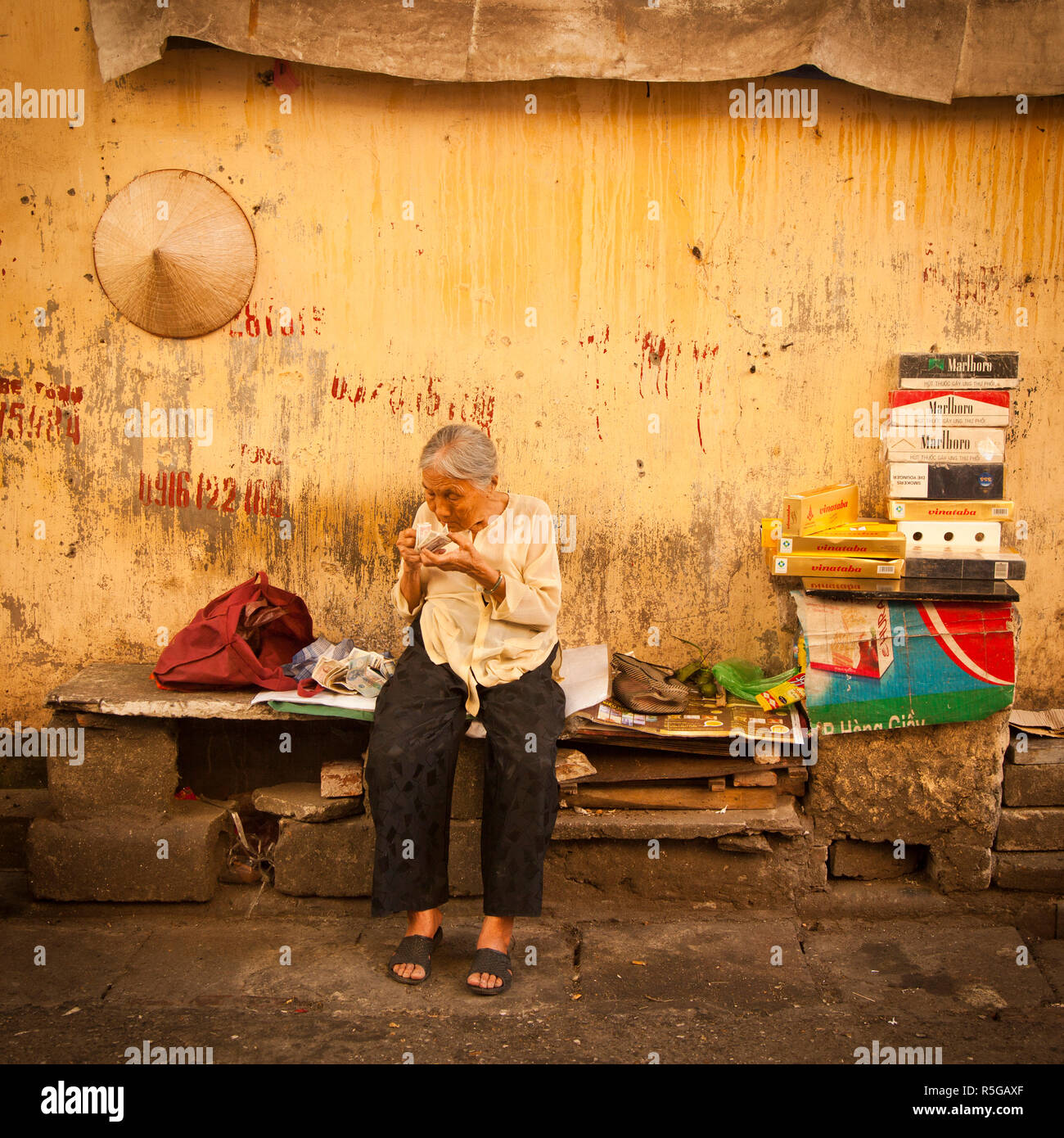 Old woman selling cigarettes, Old Quarter, Hanoi, Vietnam Stock Photo ...