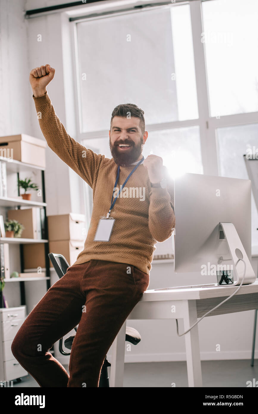 happy bearded adult businessman wearing blank security tag and holding ...