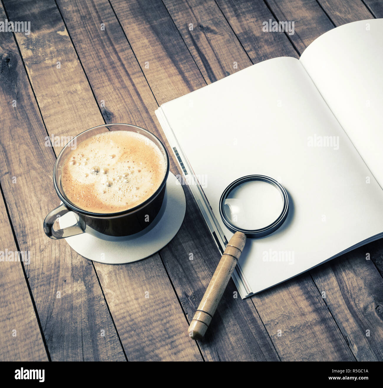 Book, magnifier, coffee cup Stock Photo - Alamy