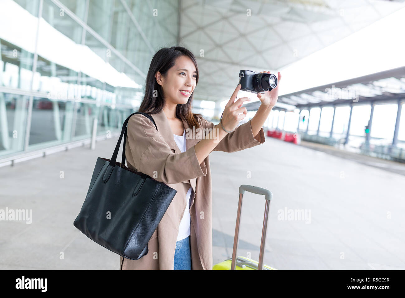 Woman taking escalator hi-res stock photography and images - Alamy