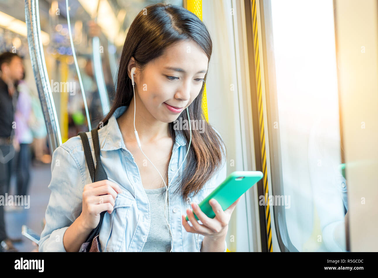 Hand using cellphone on train platform hi-res stock photography and ...