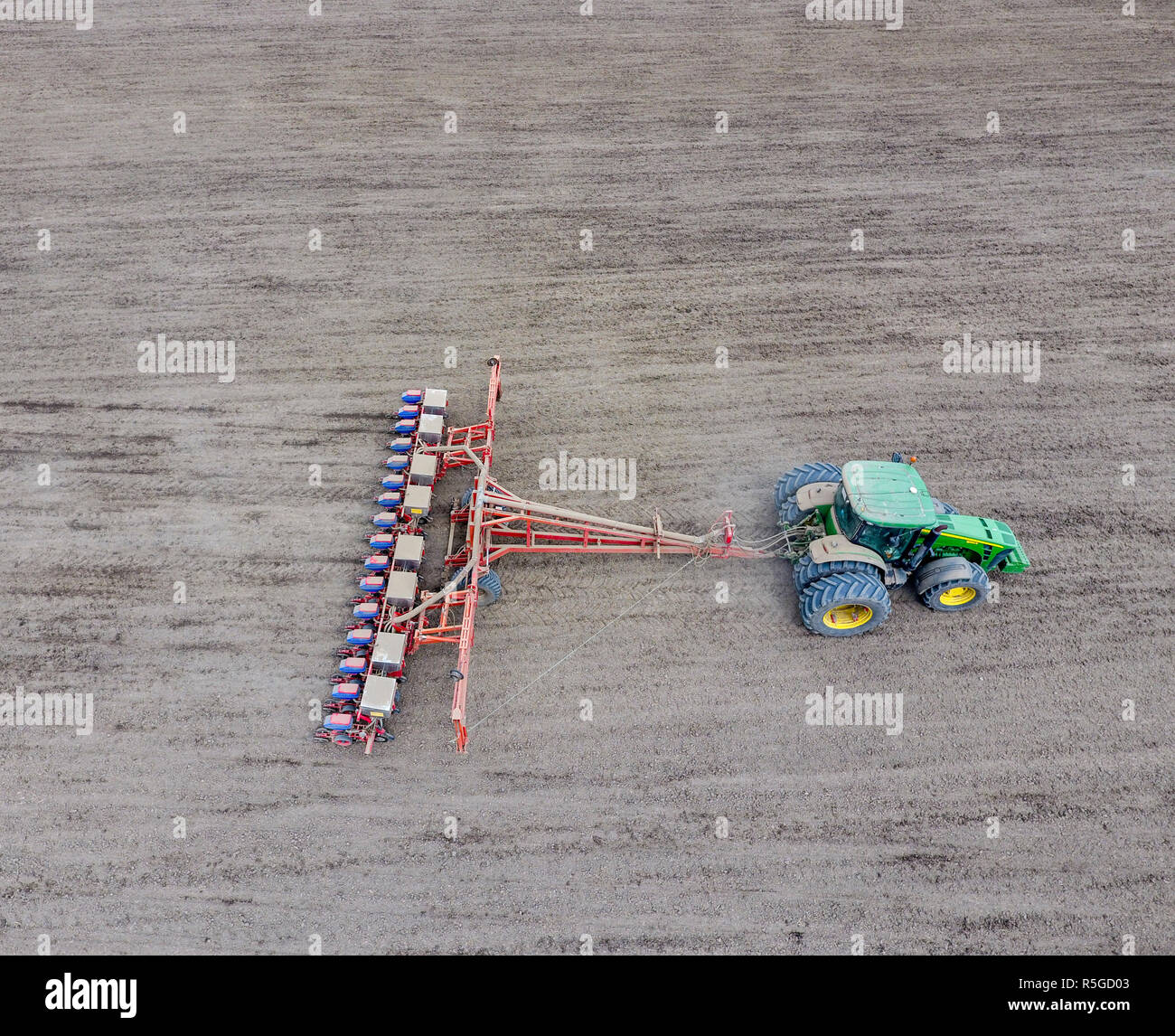Sowing of corn. Tractor with a seeder on the field. Using a seeder for ...