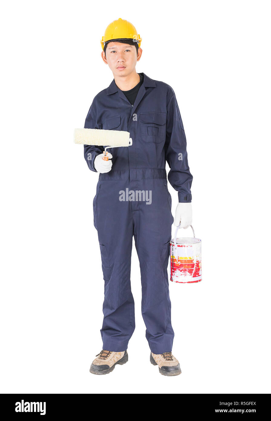 Worker in a uniform using a paint roller is painting invisible wall ...