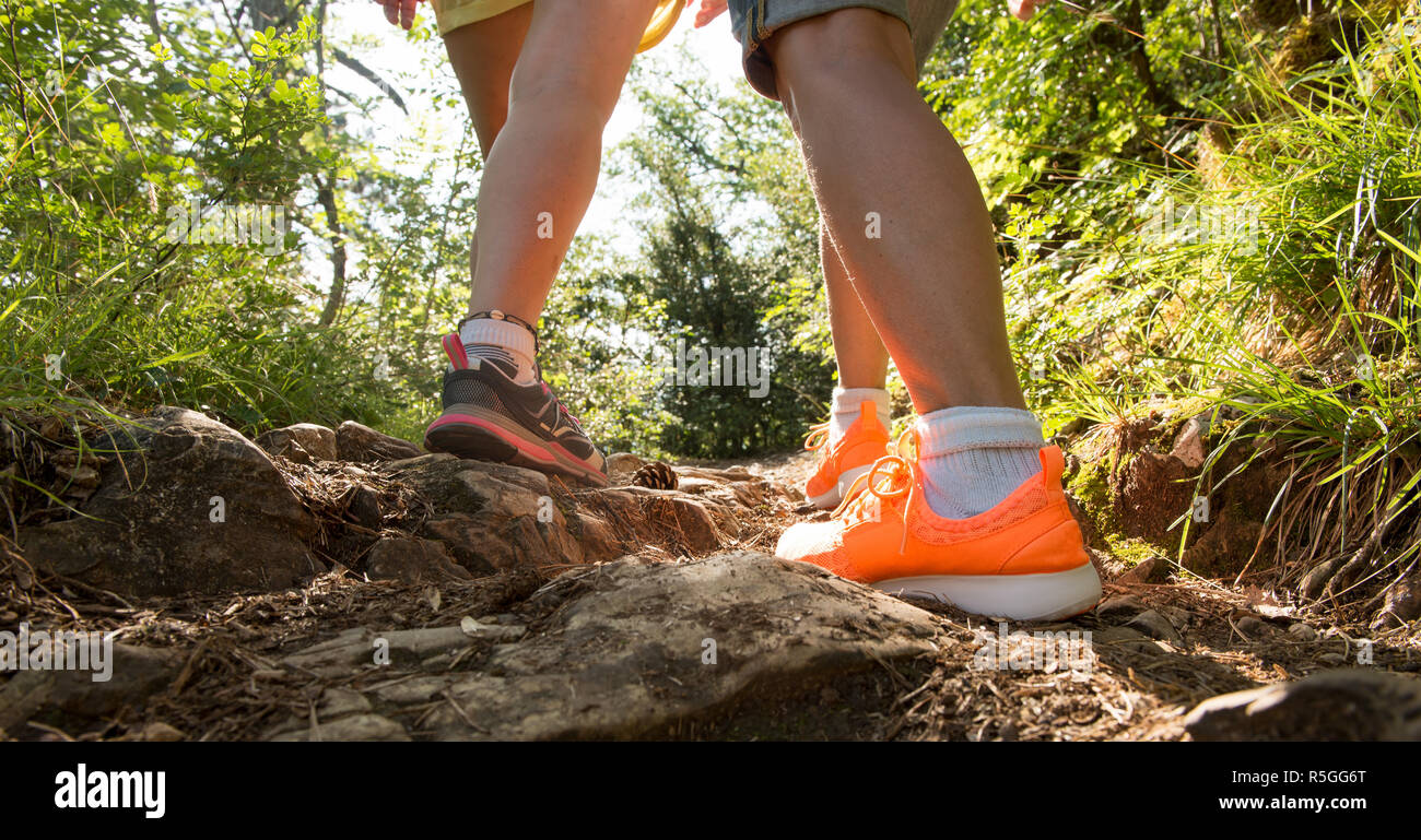 Traveler legs, two women walking on path Stock Photo - Alamy