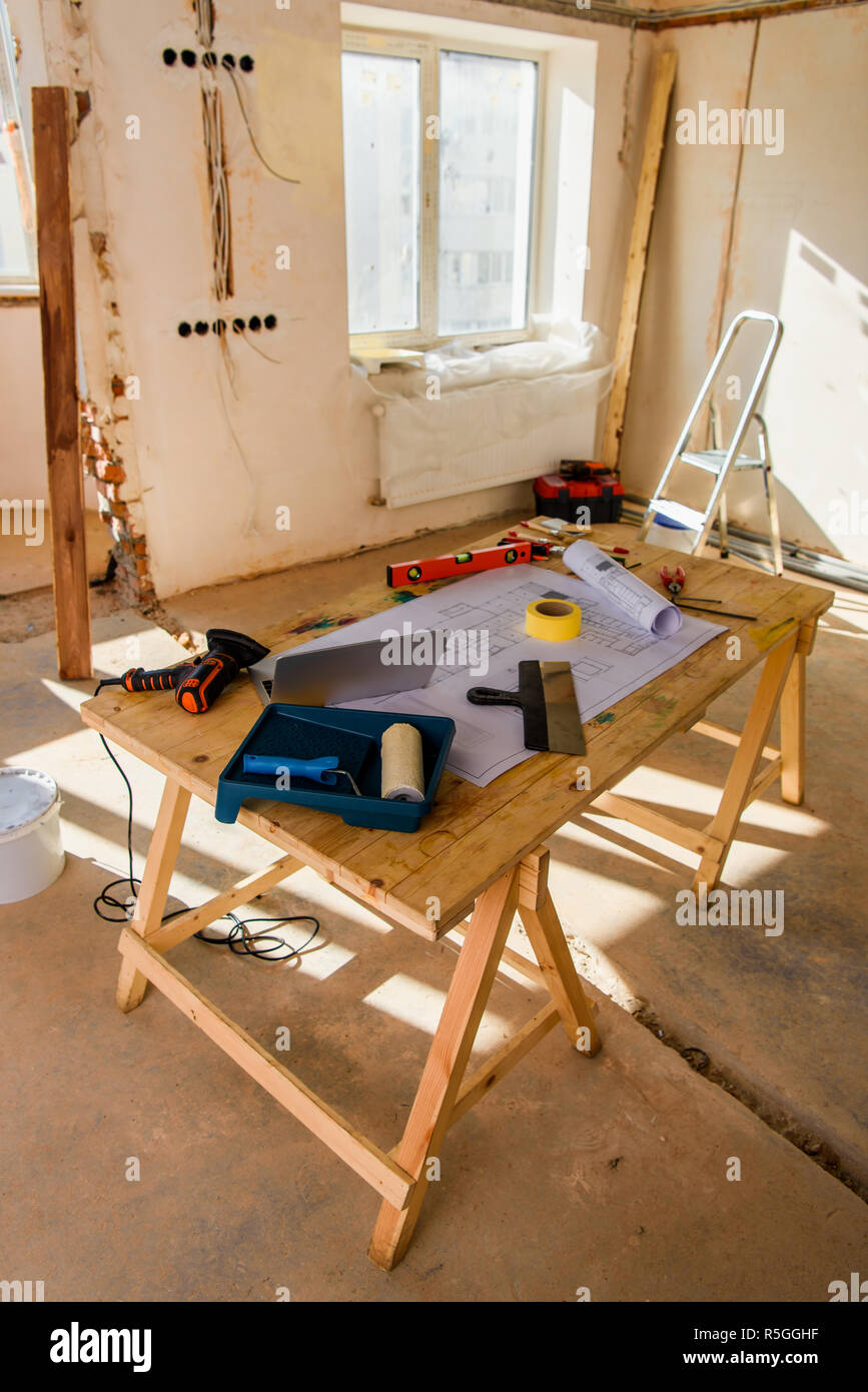 high angle view of room with table with blueprint and laptop during ...