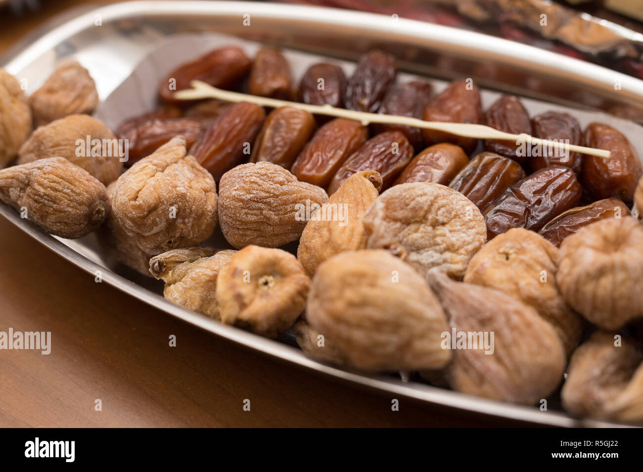 dried figs and dates on a tray Stock Photo - Alamy