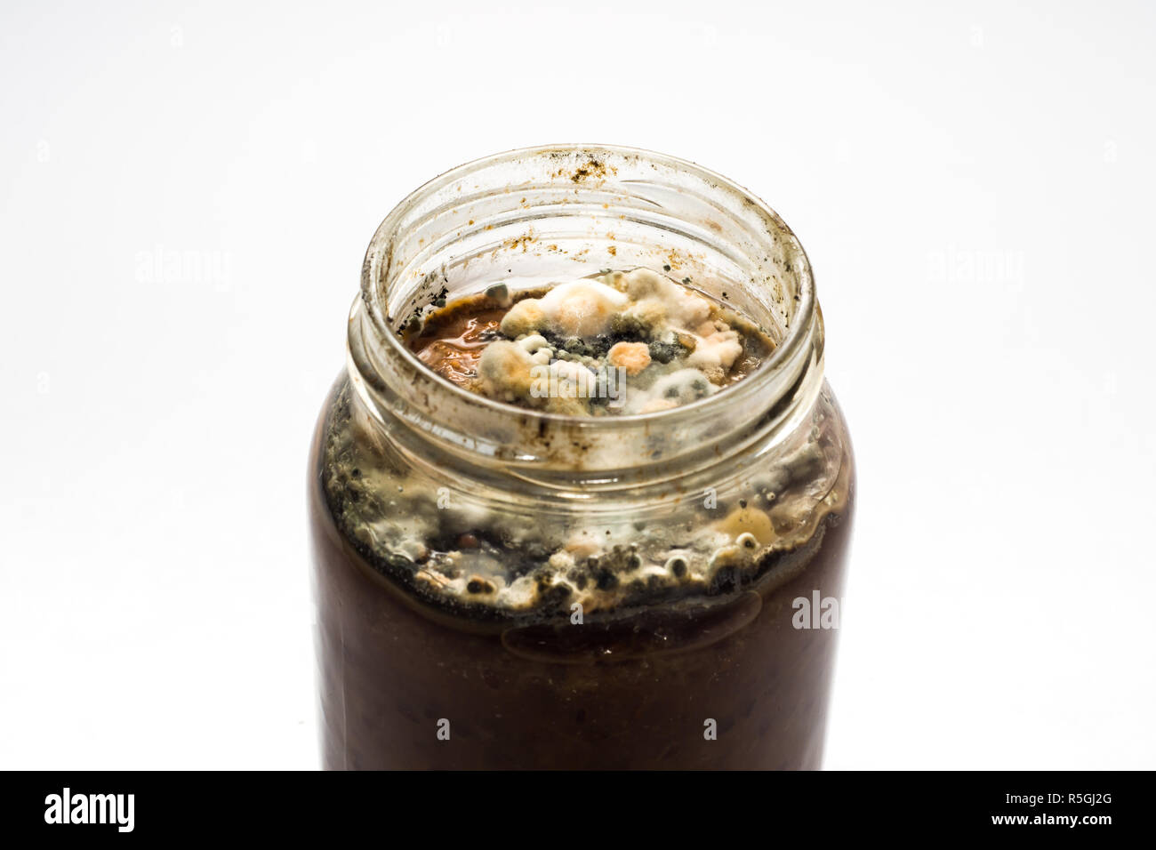 Mold on a jar of jam isolated on white background Stock Photo - Alamy