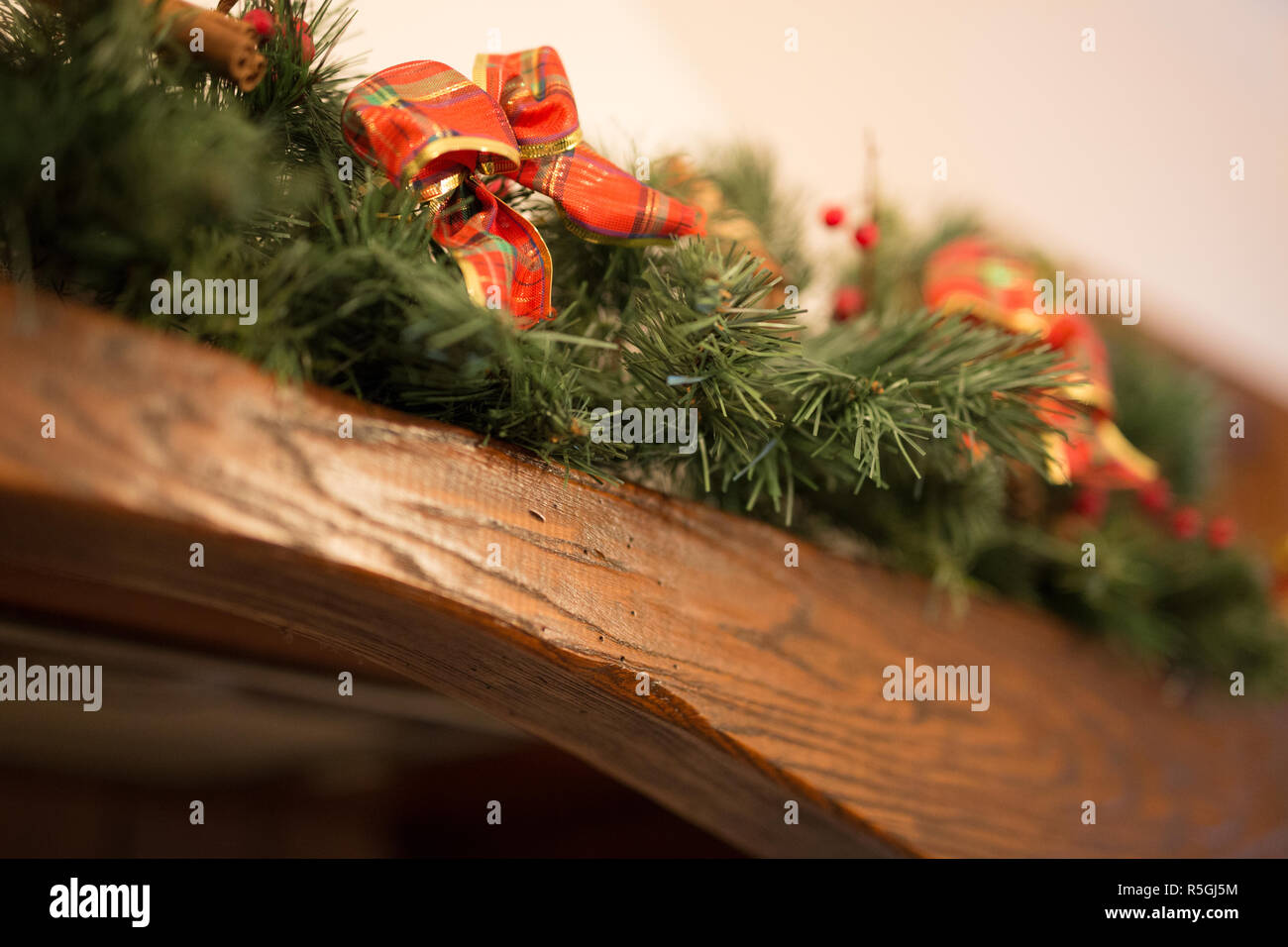 red christmas bow on fireplace Stock Photo - Alamy
