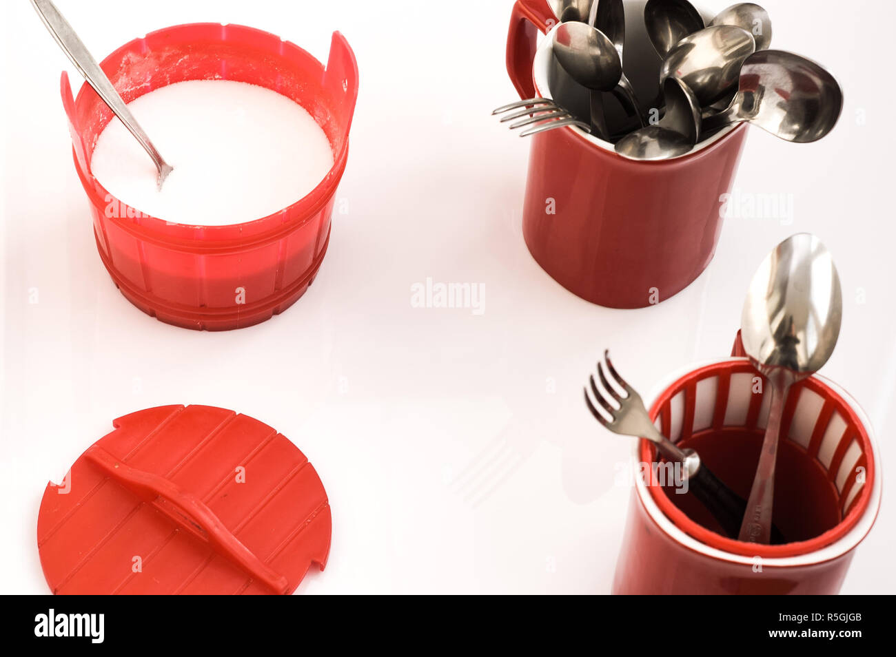 Salt shaker and kitchen utensils in red cup on a white background Stock ...
