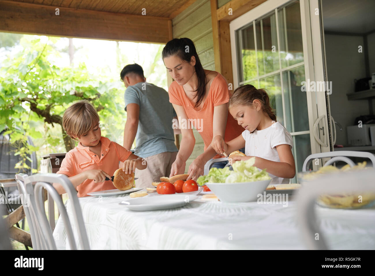 Family on vacation preparing outdoor lunch Stock Photo - Alamy