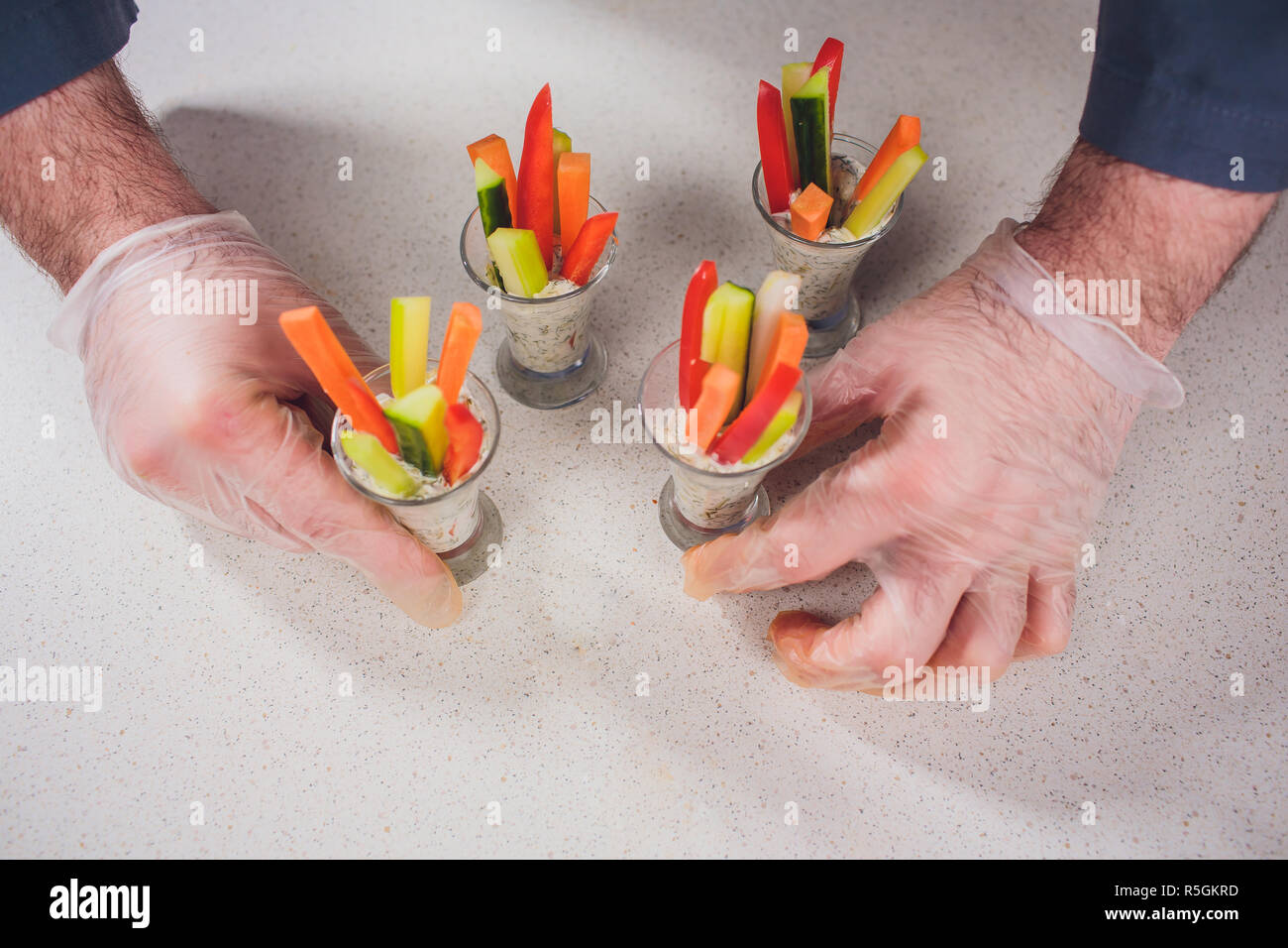 Chief cook preparing fresh salad with sauce in glass fresh Stock Photo ...