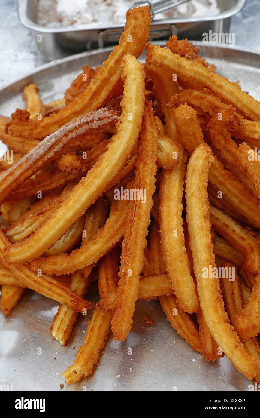 Heap of sweet fresh churros snack close up Stock Photo - Alamy