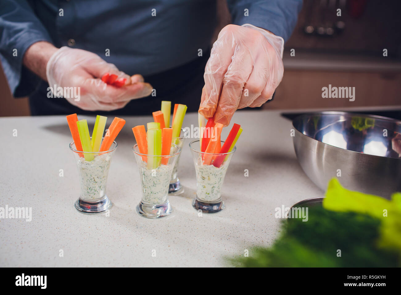Chief cook preparing fresh salad with sauce in glass fresh Stock Photo ...
