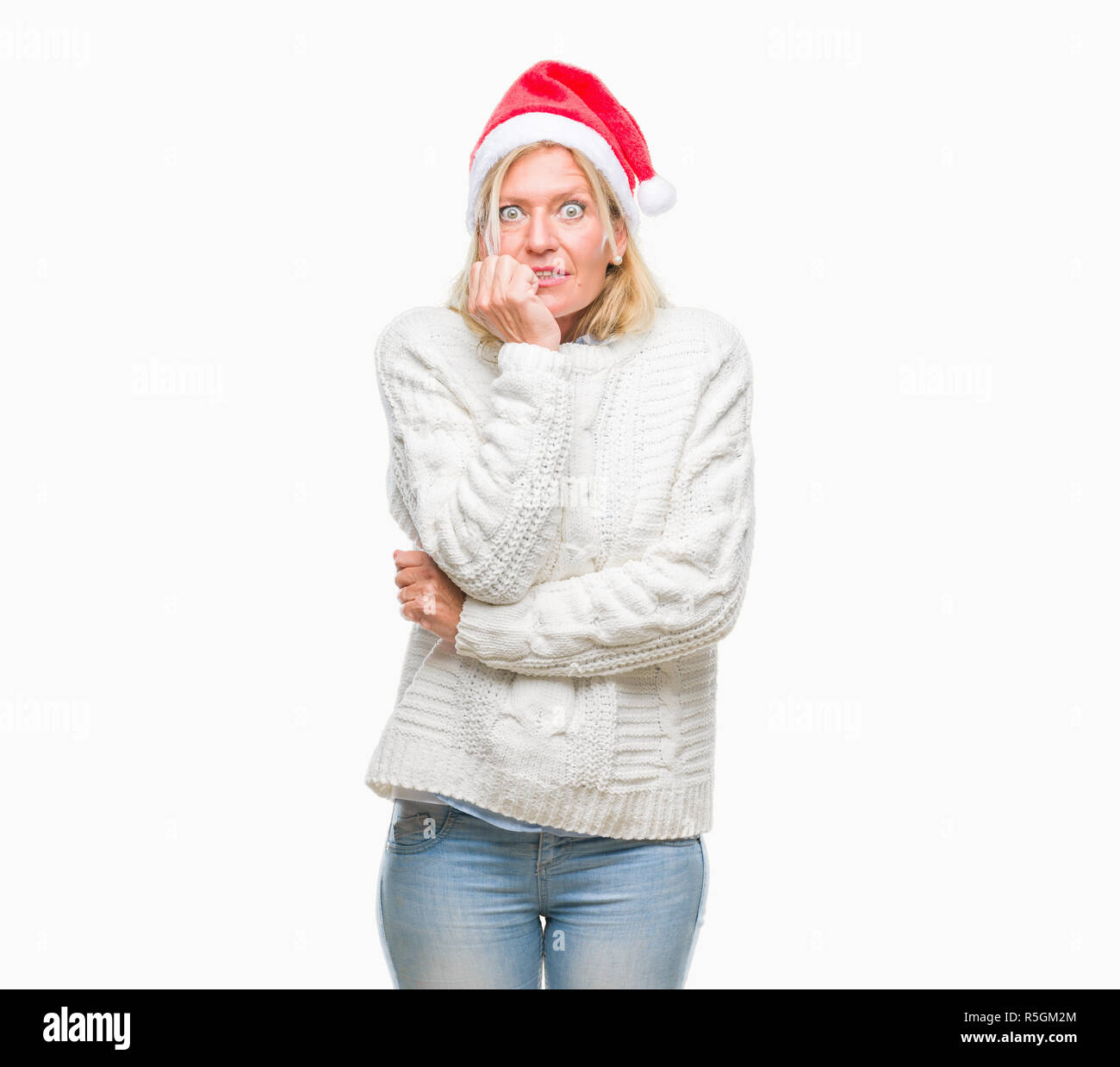 Middle age blonde woman wearing christmas hat over isolated background ...