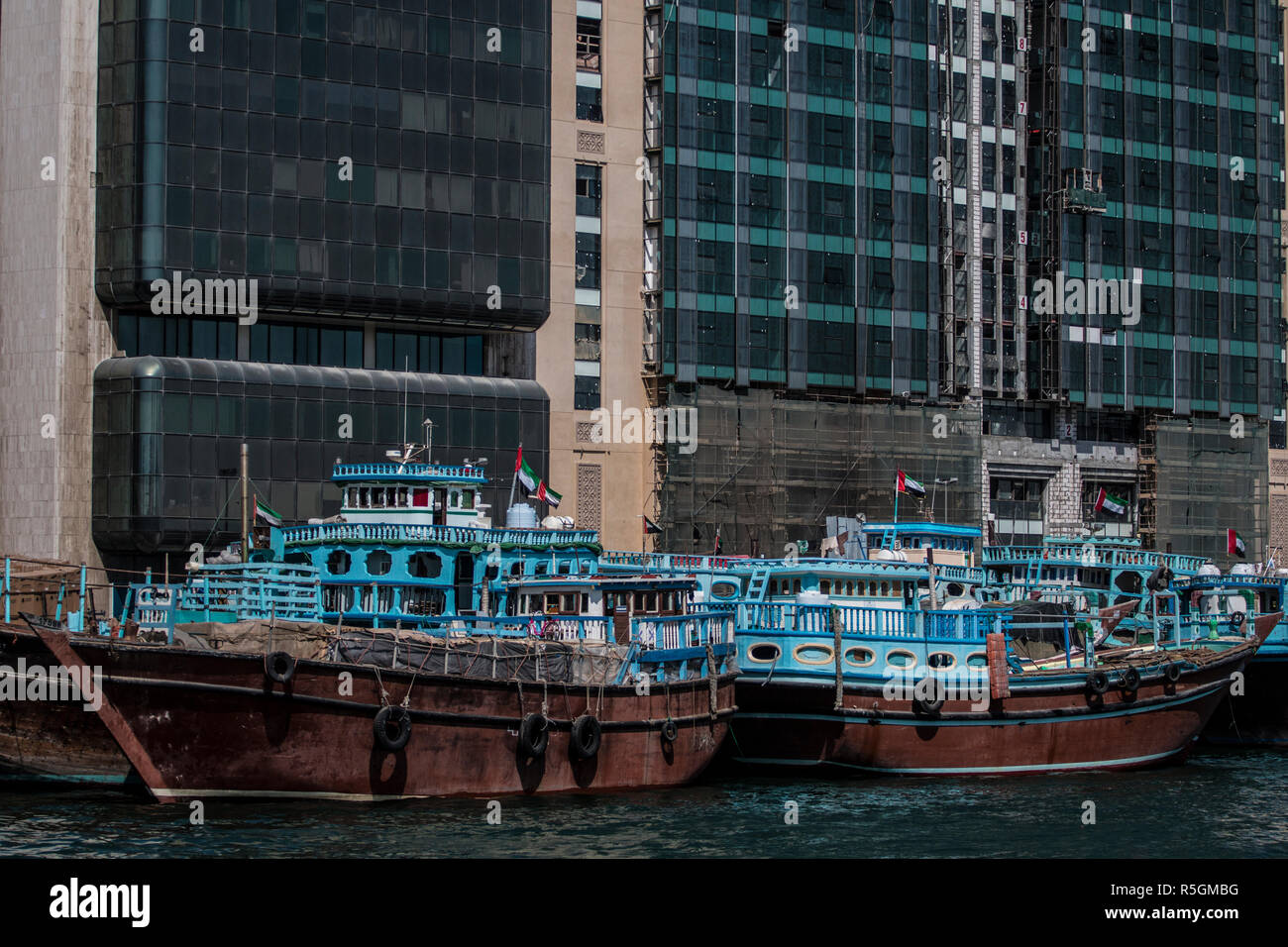 Vintage wooden barges moored in Dubai Creek, waiting for loading ...