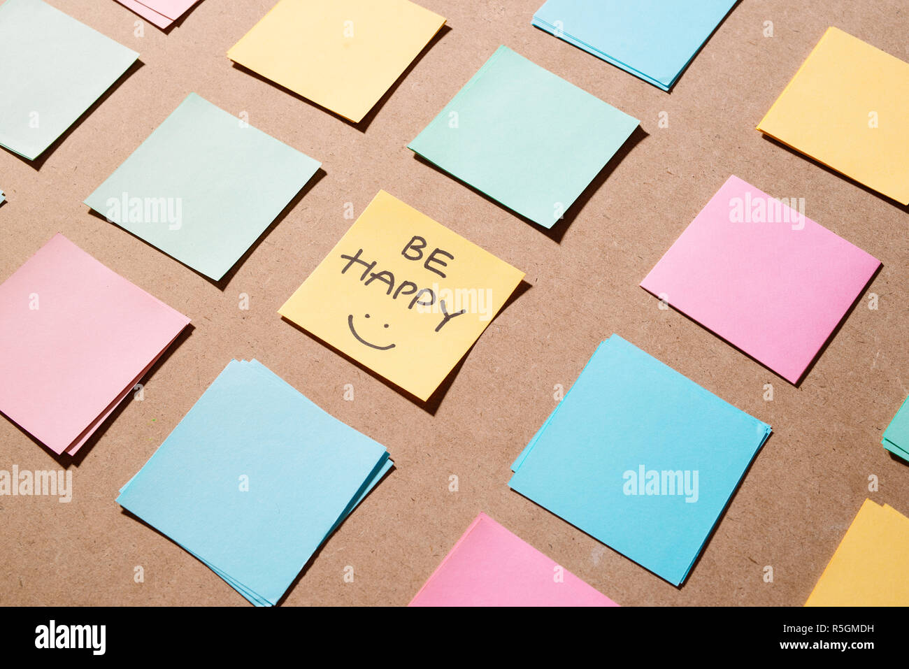 Sticks note paper with text - Be happy on wood background for remind ...