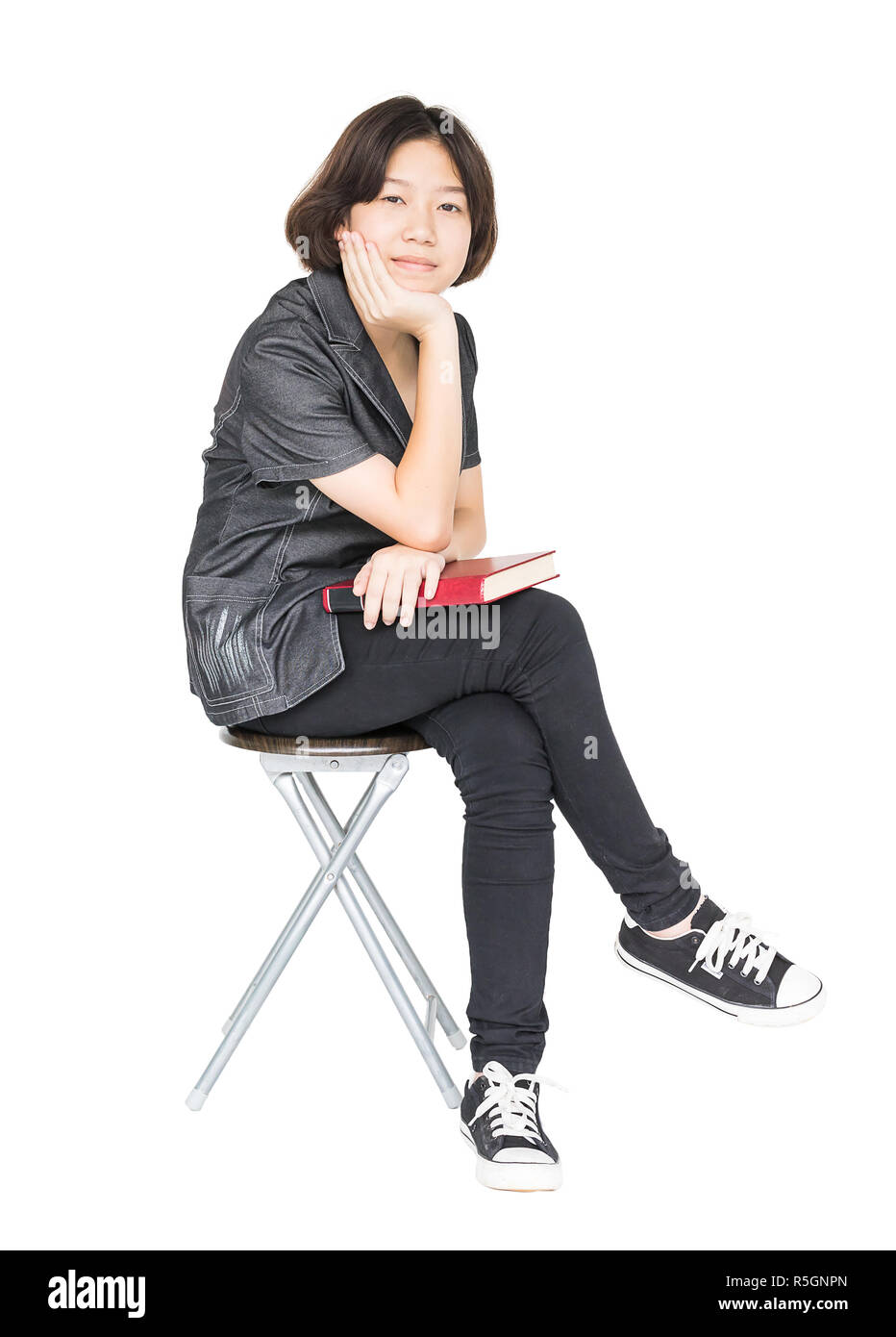 Woman reading a book sitting on chair Stock Photo - Alamy