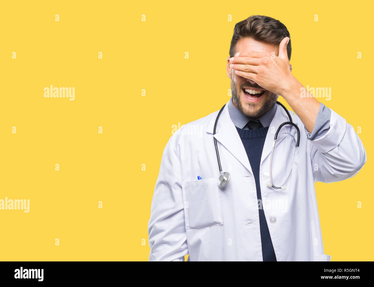 Young handsome doctor man over isolated background smiling and laughing ...