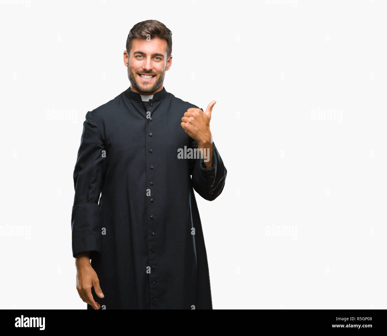 Young catholic christian priest man over isolated background smiling ...