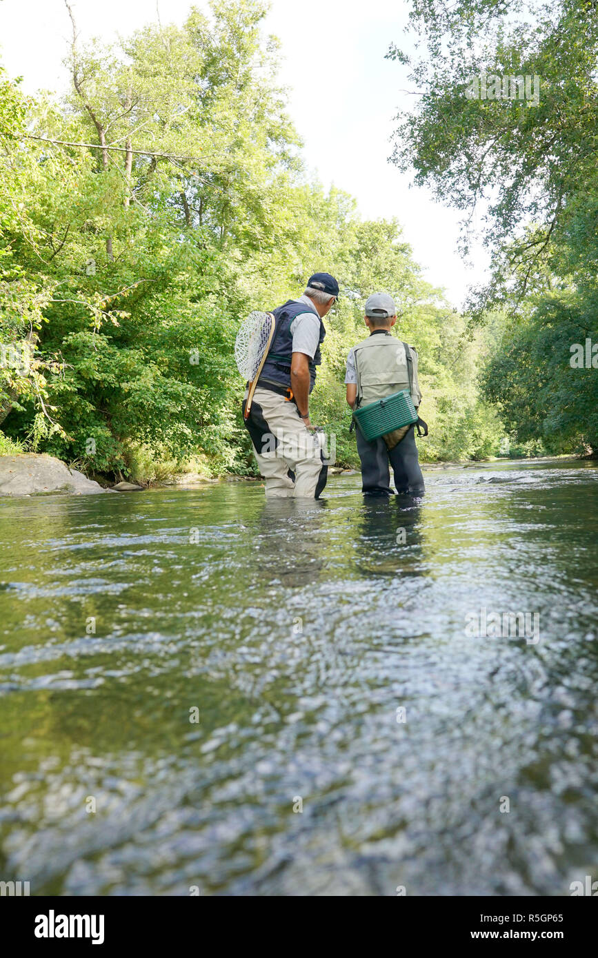 Father and son fly-fishing in river Stock Photo - Alamy