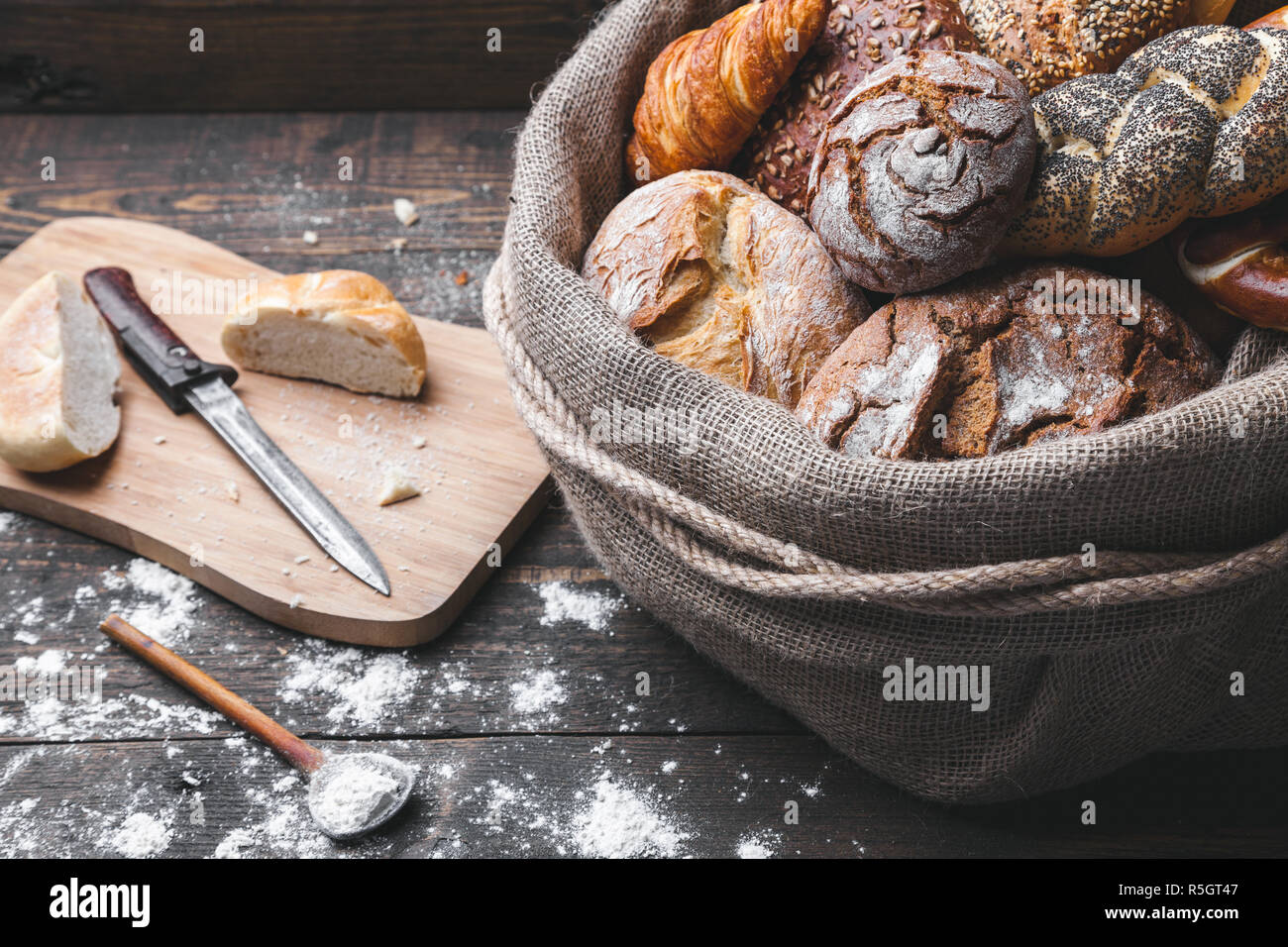 Delicious fresh bread inside a sack on wooden background Stock Photo ...