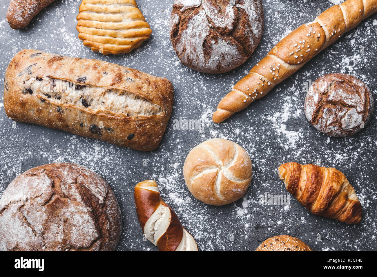 Delicious fresh bread on rustic background Stock Photo - Alamy