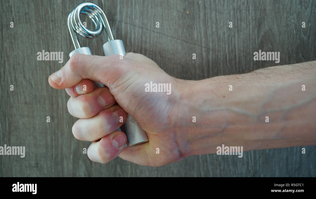 hand expander in the hand of a young athlete Stock Photo - Alamy