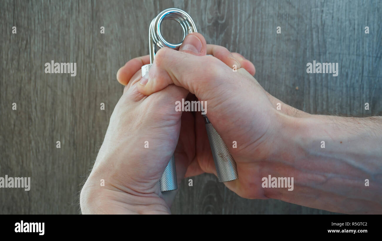 hand expander in the hand of a young athlete Stock Photo - Alamy
