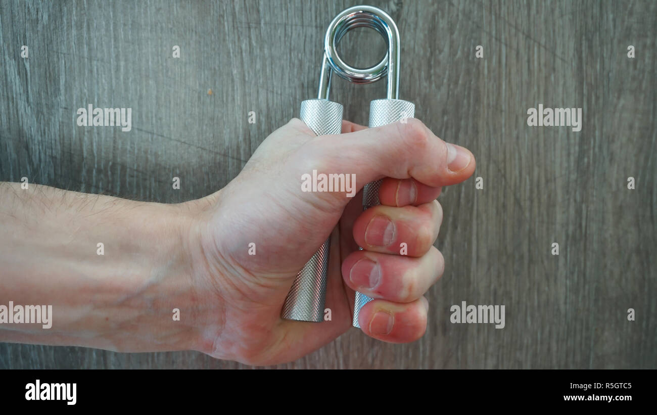 hand expander in the hand of a young athlete Stock Photo - Alamy