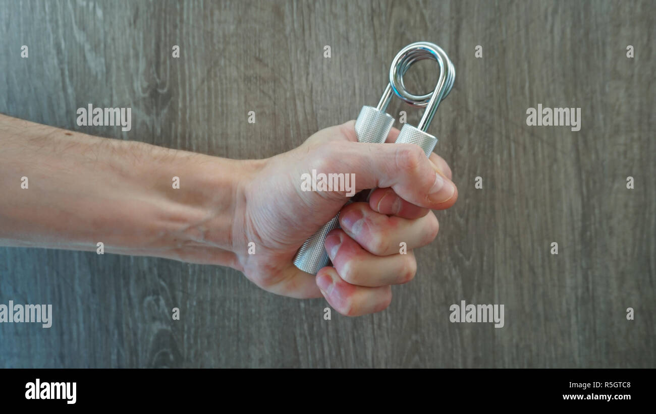hand expander in the hand of a young athlete Stock Photo - Alamy