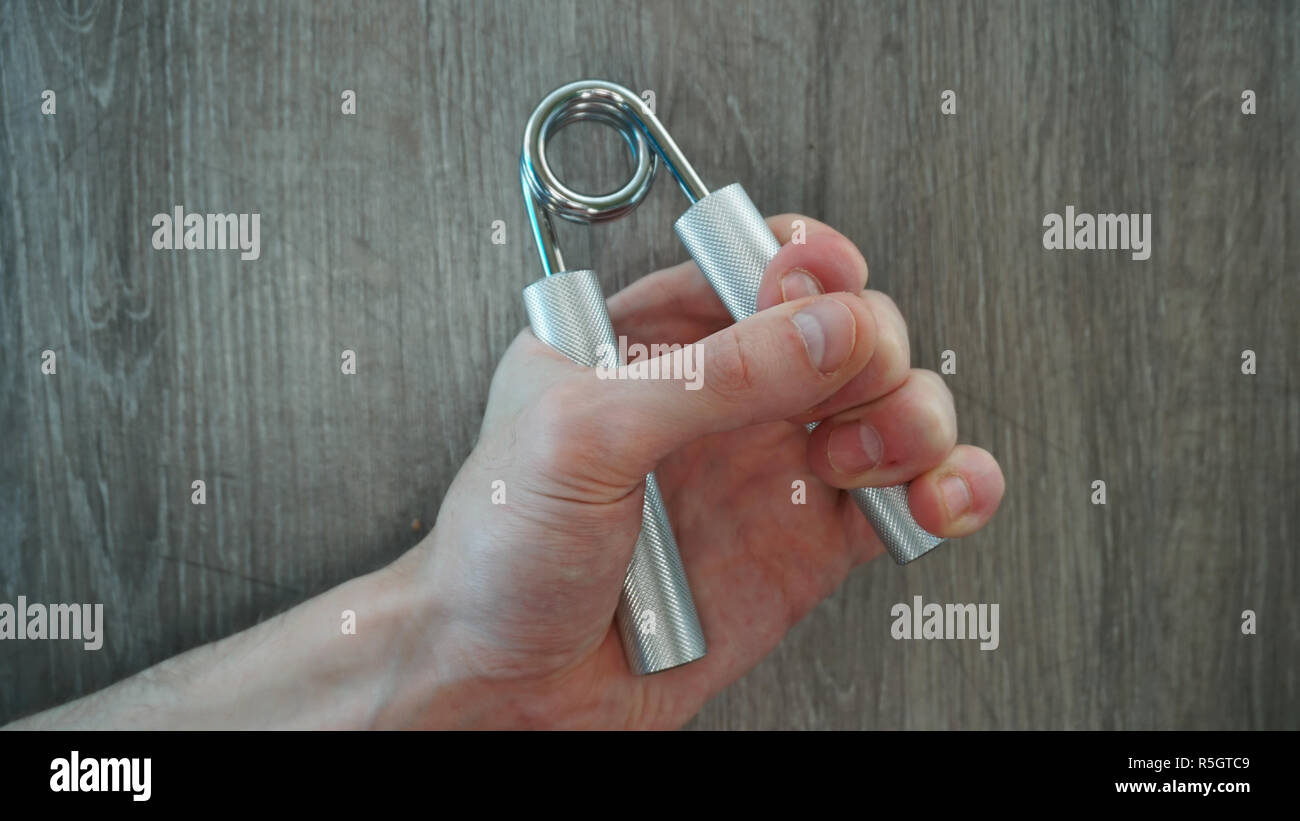 hand expander in the hand of a young athlete Stock Photo - Alamy