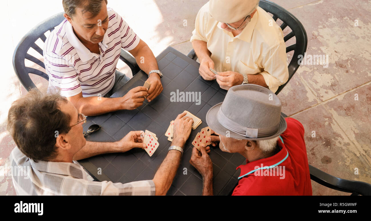 Group Of Senior Men Playing Cards Game In Patio Stock Photo - Alamy