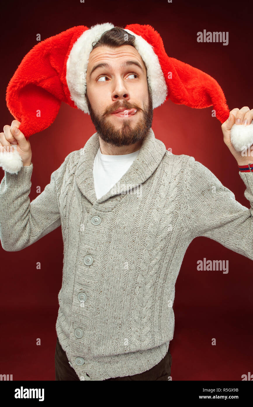 Surprised christmas man wearing a santa hat Stock Photo - Alamy