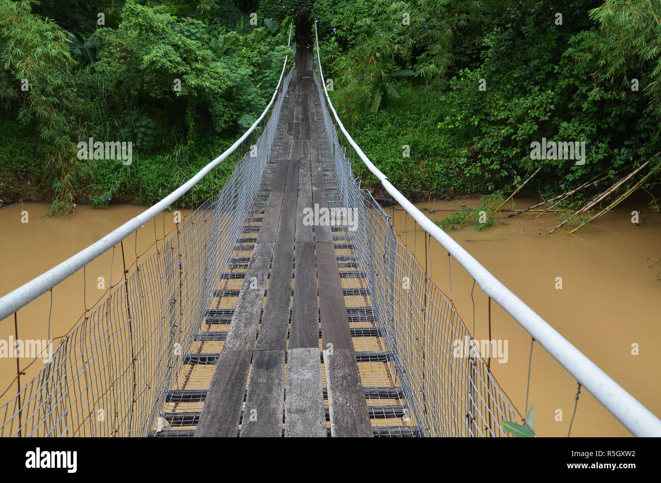 Hanging bridge over river Stock Photo - Alamy