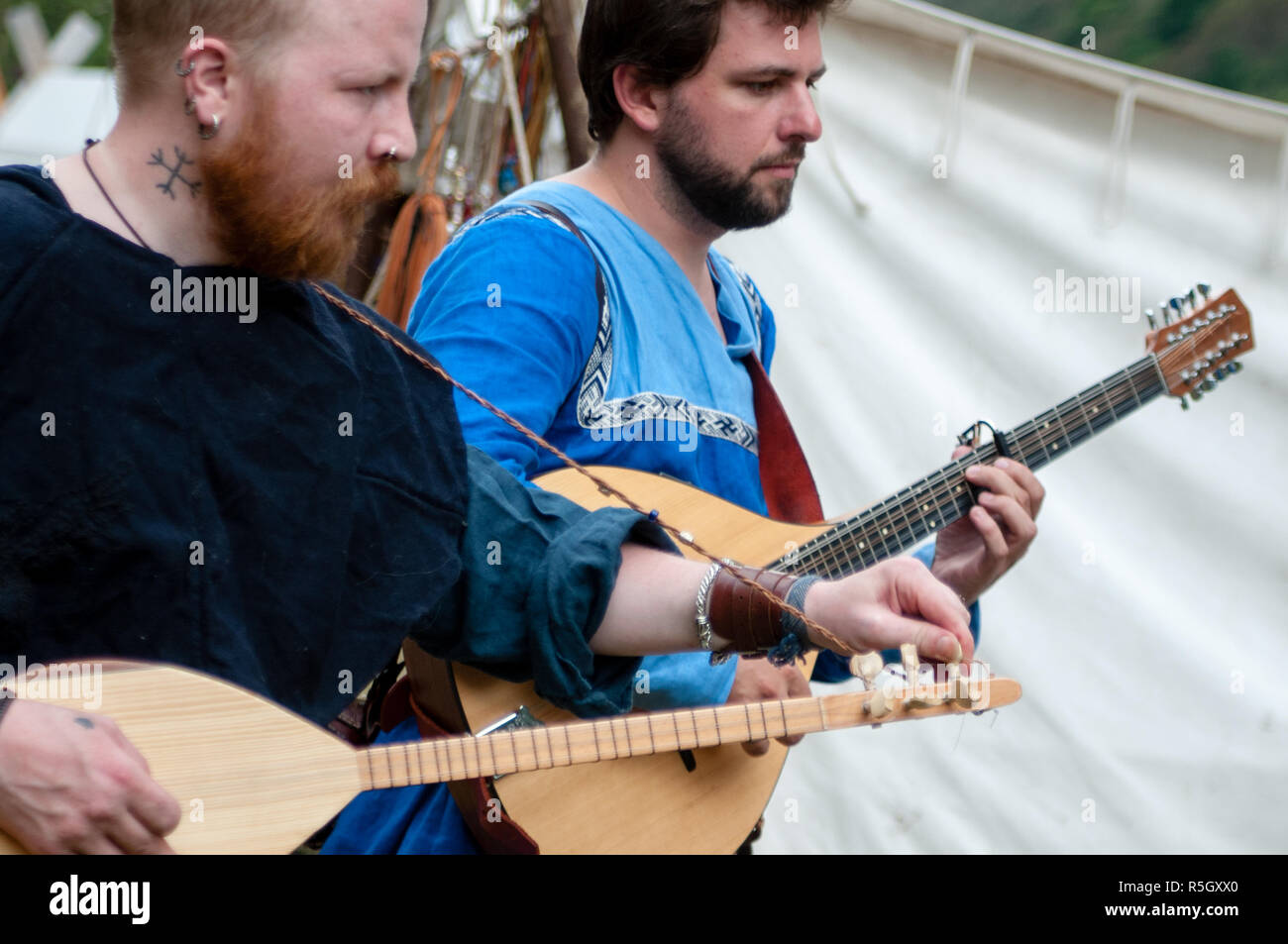 Two viking re-enactors playing stringed musical instruments at ...