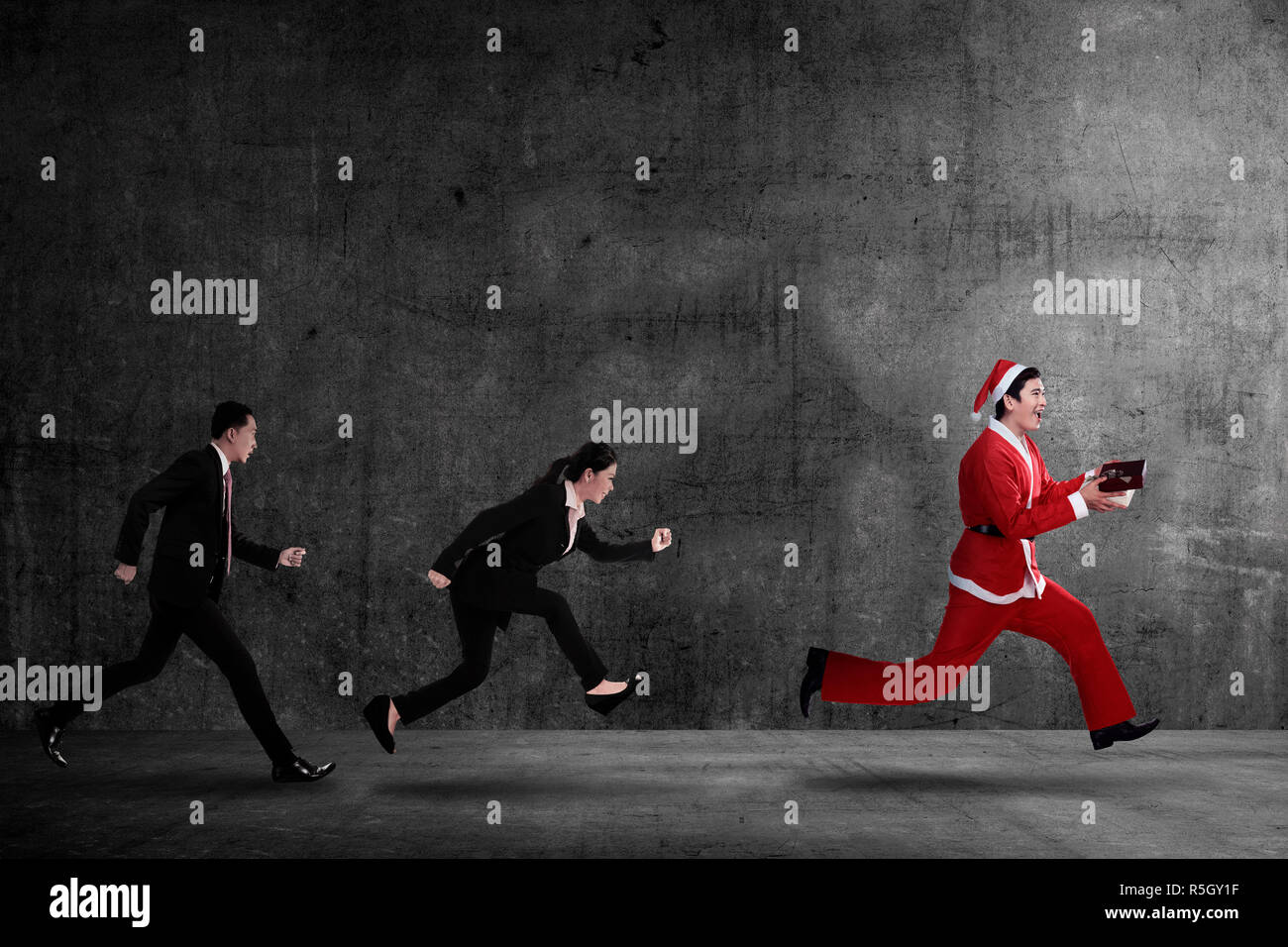 Business people chasing santa claus Stock Photo - Alamy