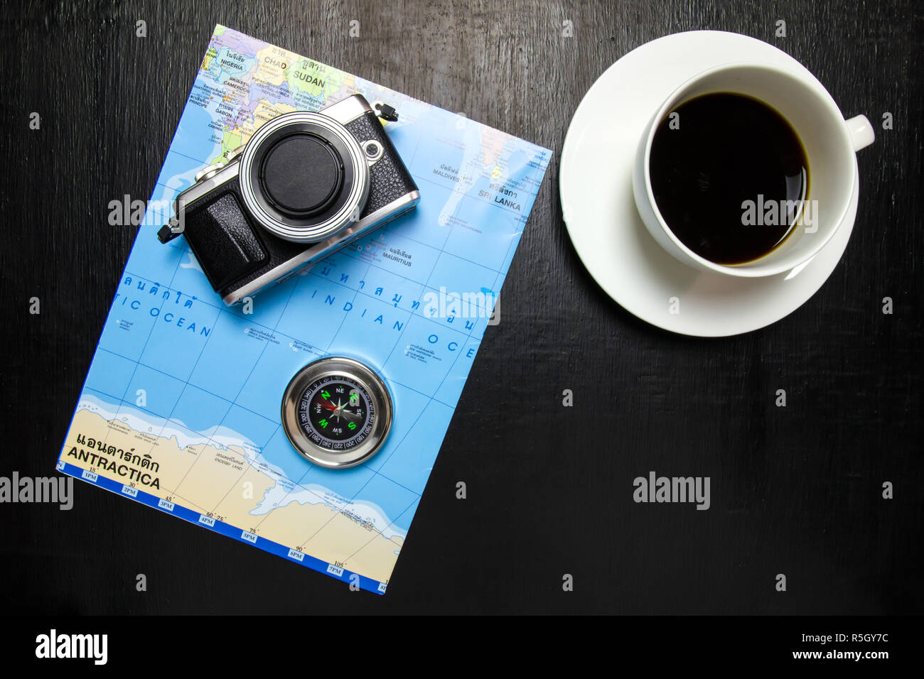 Top view of office desk workspace with coffee cup, camera ,world map ...