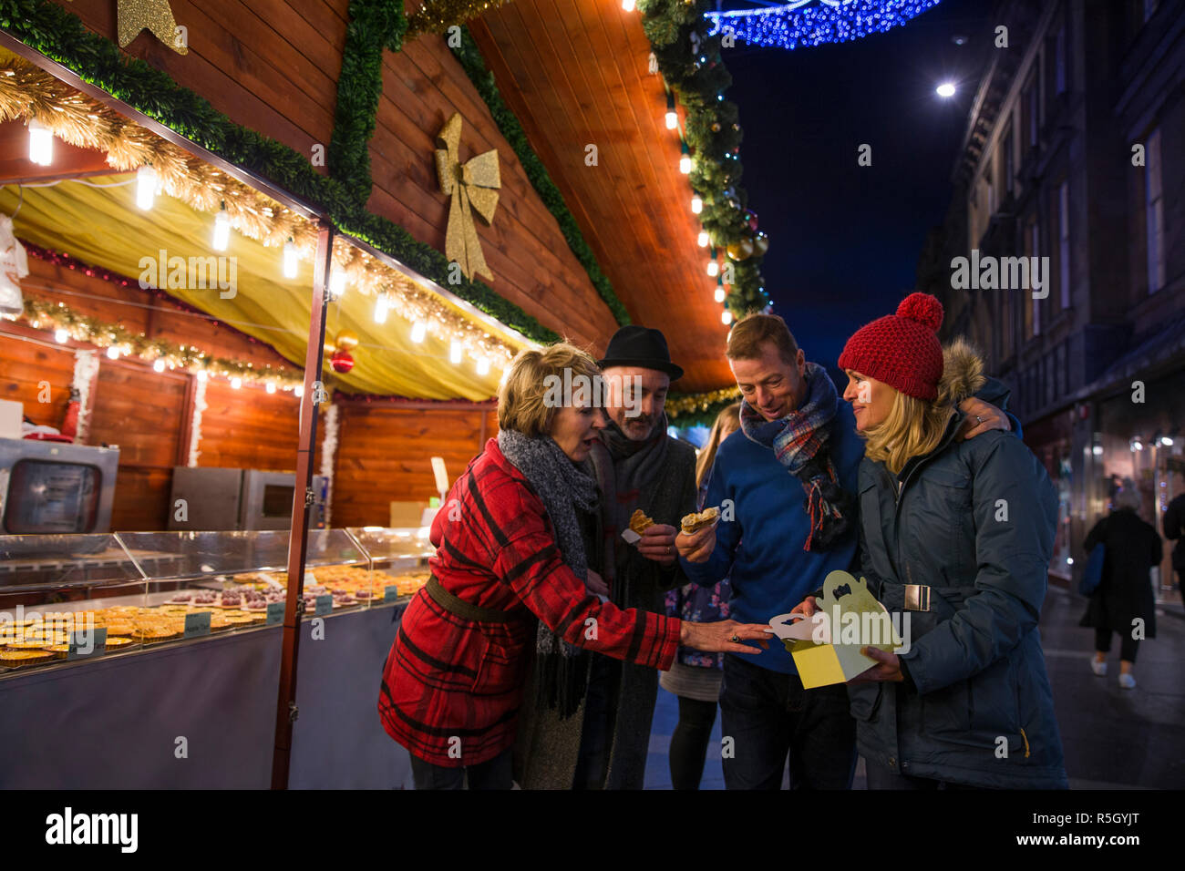 Sharing Waffles At The Christmas Market Stock Photo - Alamy