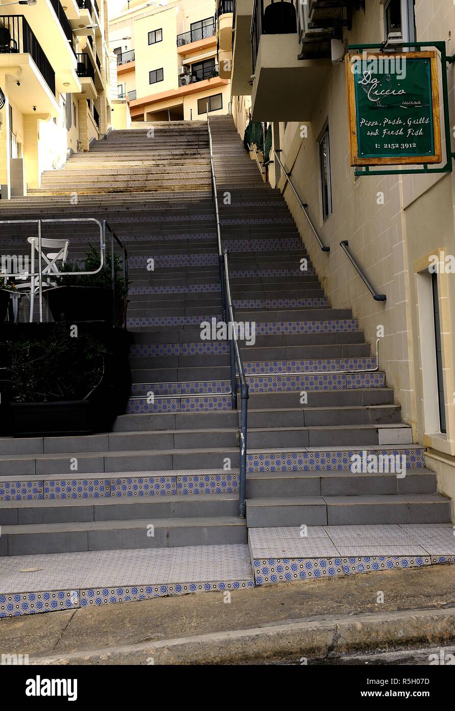 Mellieha, Malta - 4th October 2018:Handrail and a large flight of steps ...