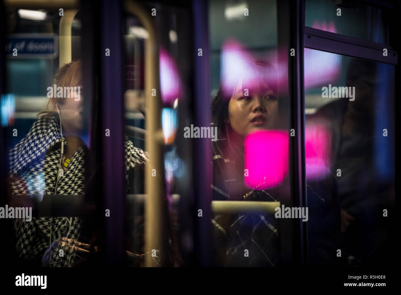 LONDON - NOVEMBER 26, 2018: Passengers ride on the back seat of a ...