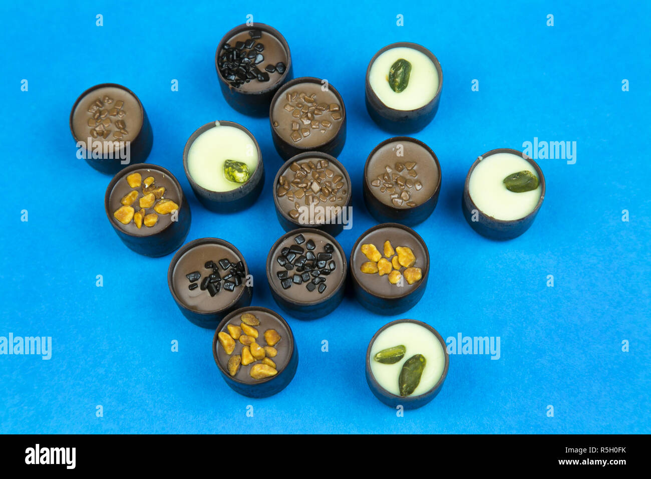 Candies with different fillings laid out on a color table Stock Photo ...