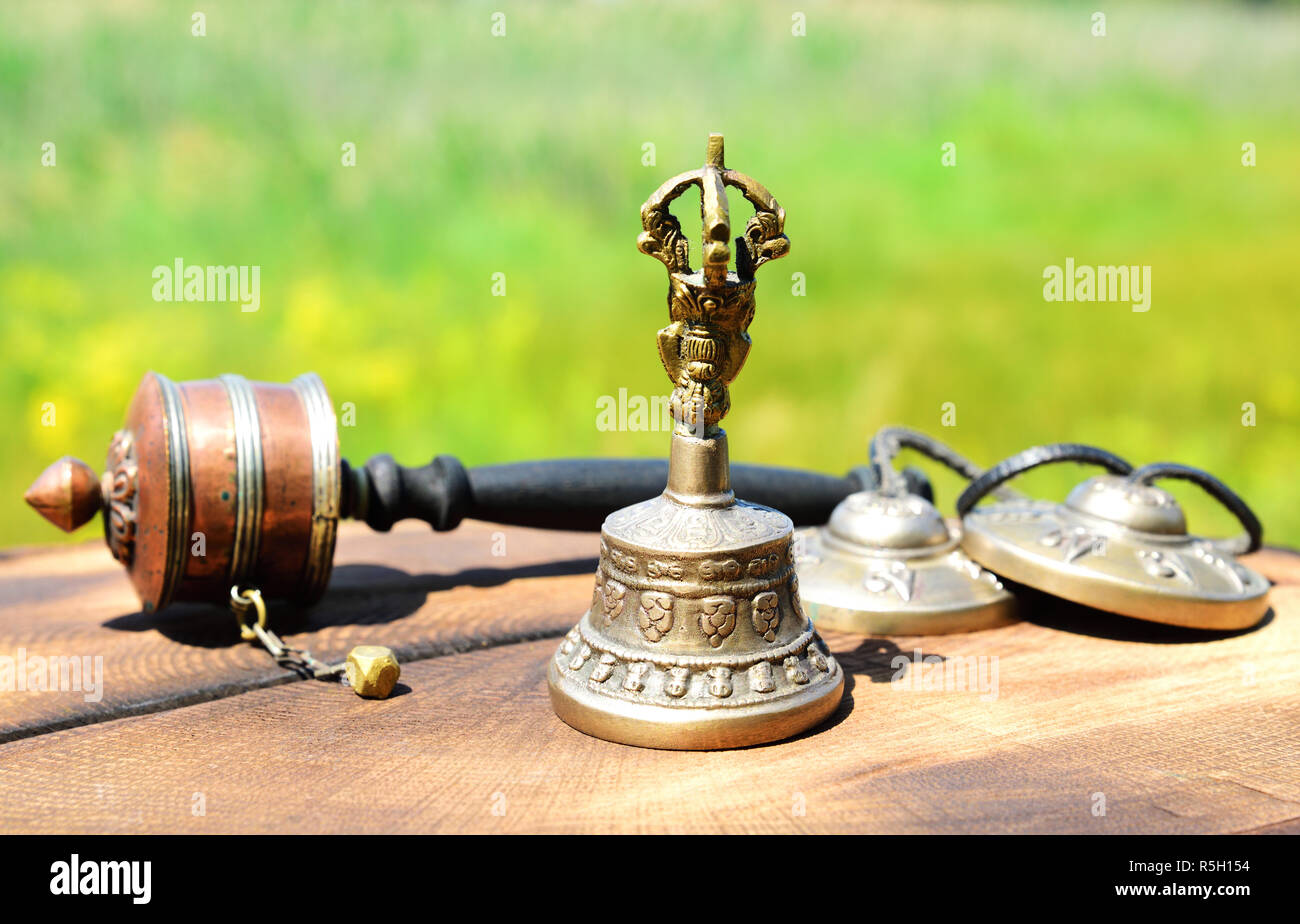 copper bell with Tibetan religious objects, close up Stock Photo - Alamy