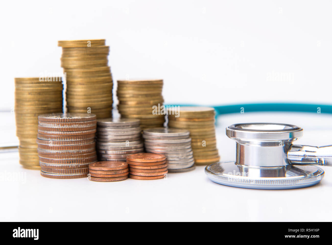 coin stack growing business with medical instruments stethoscope ...
