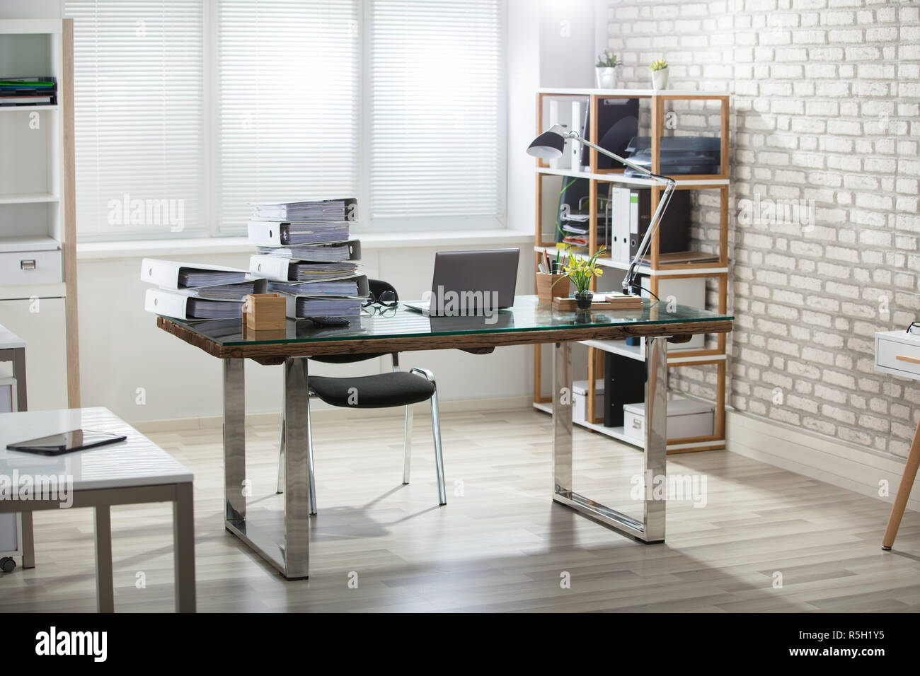 Stack Of Folders On Office Desk Stock Photo - Alamy