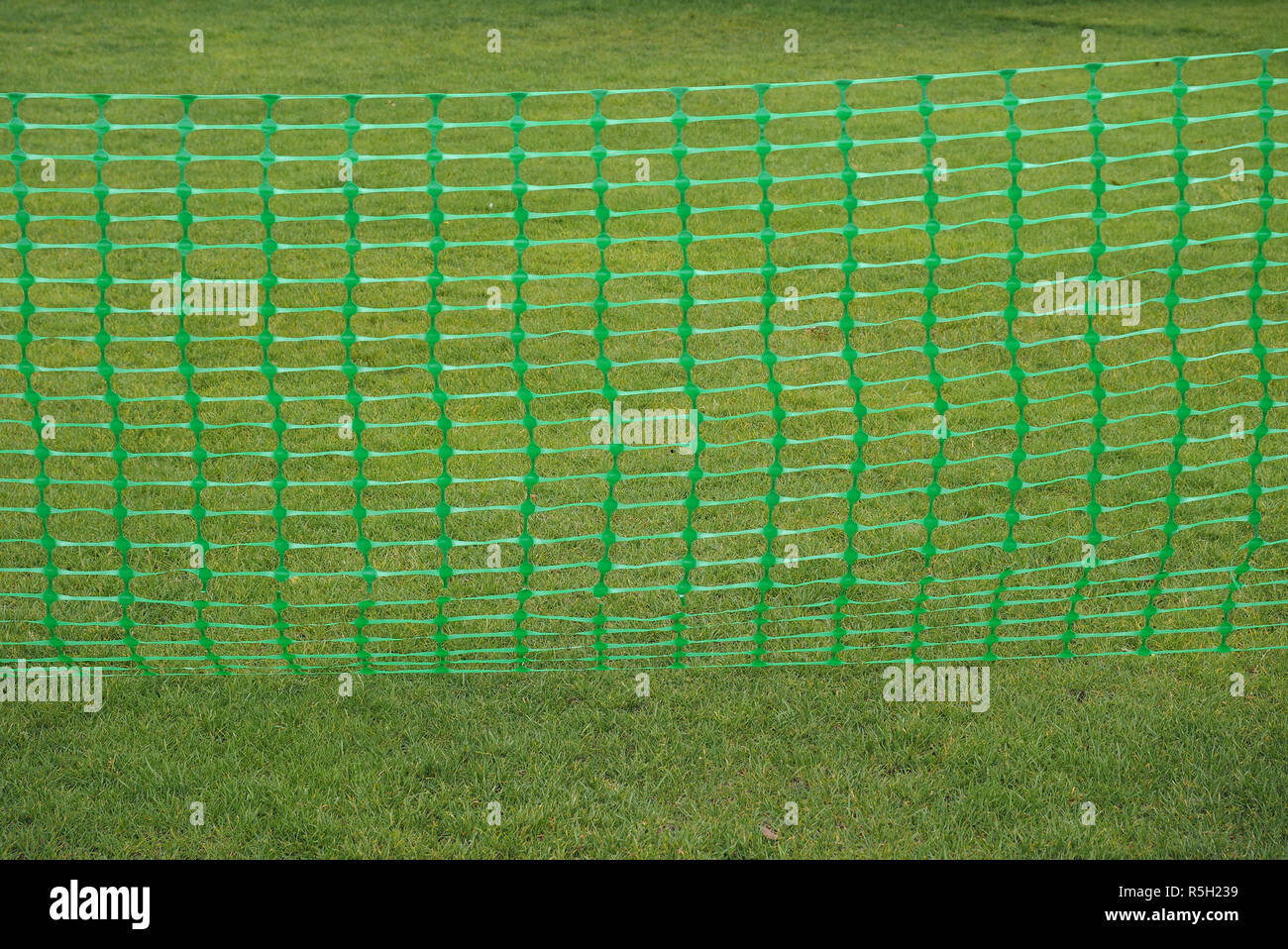 green plastic temporary fence Stock Photo - Alamy