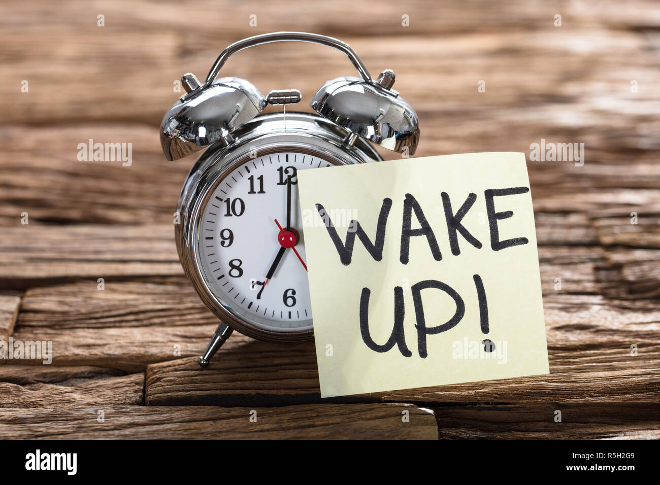 Alarm Clock With Wake Up Text On Sticky Note Stock Photo - Alamy