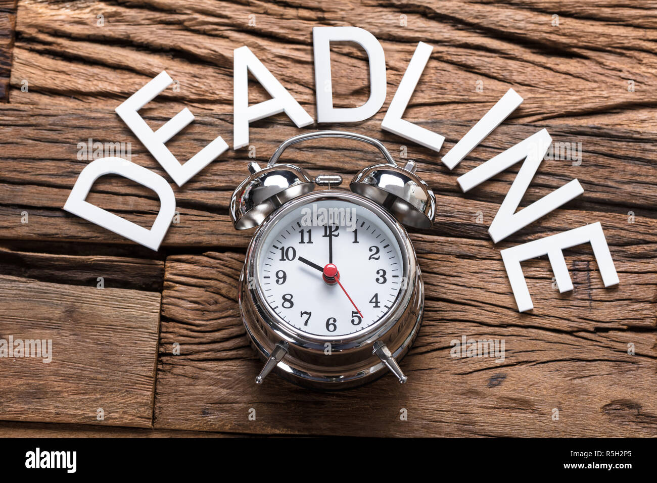 Deadline Text By Alarm Clock On Wooden Table Stock Photo - Alamy